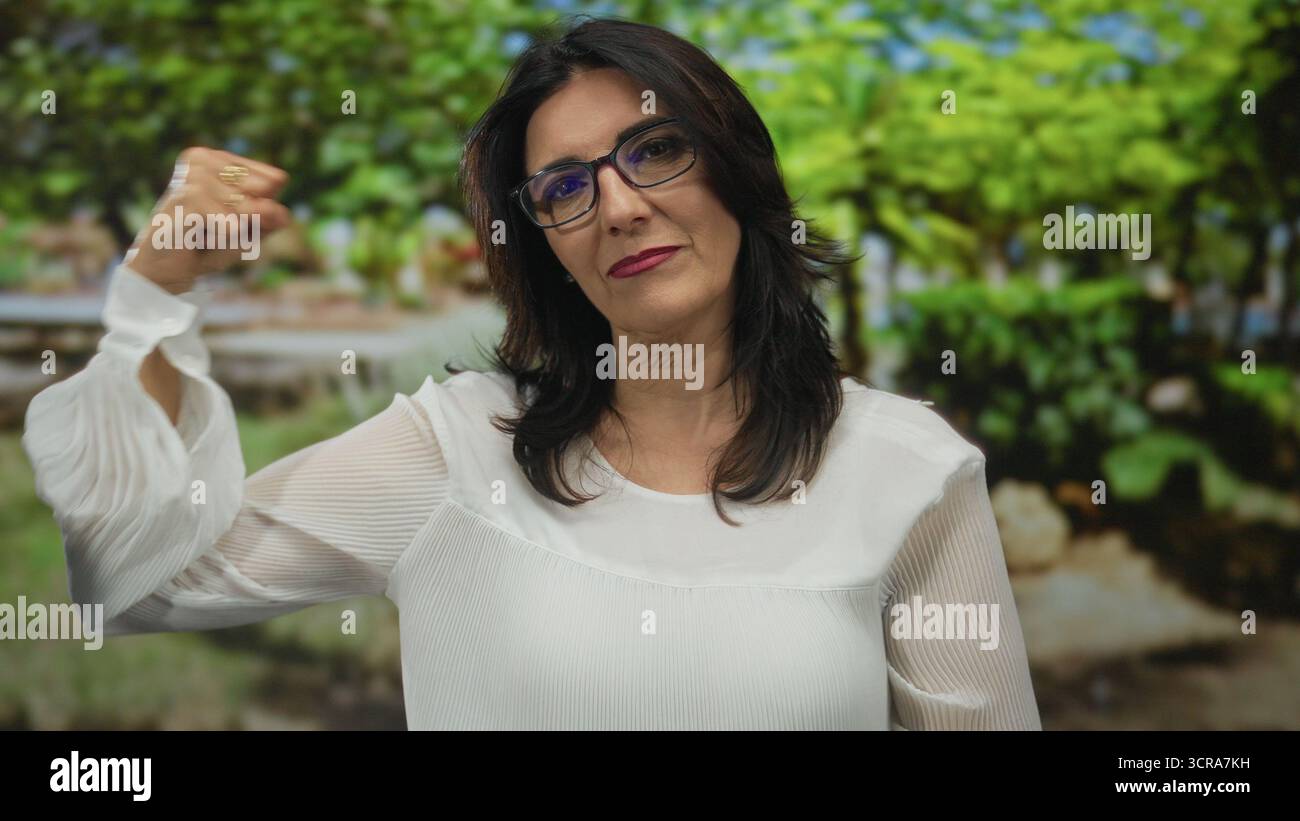Woman flexes bicep gesture in hi-res stock photography and images - Alamy