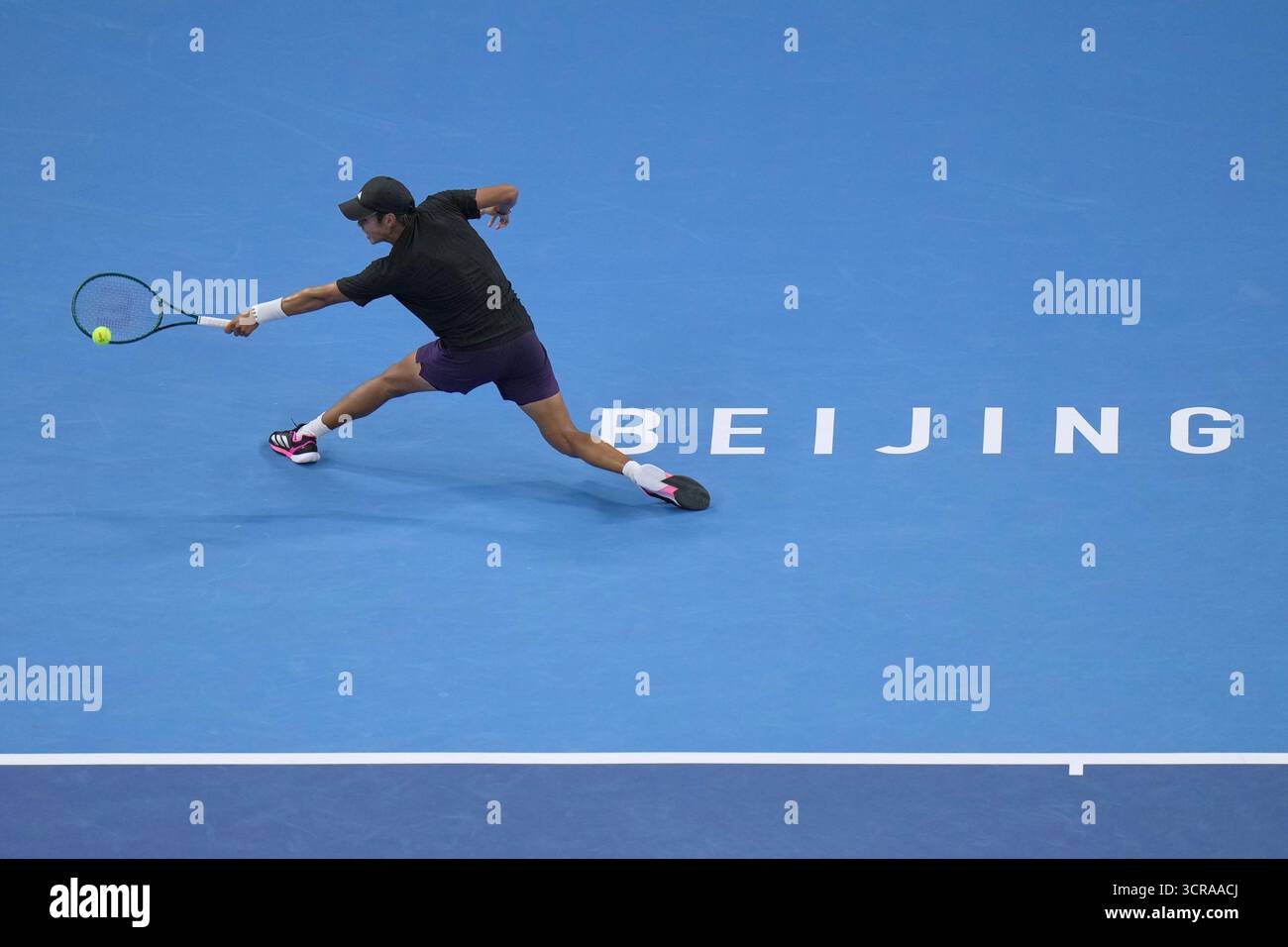 Learner Tien, of the United States returns a backhand shot from Daniil ...