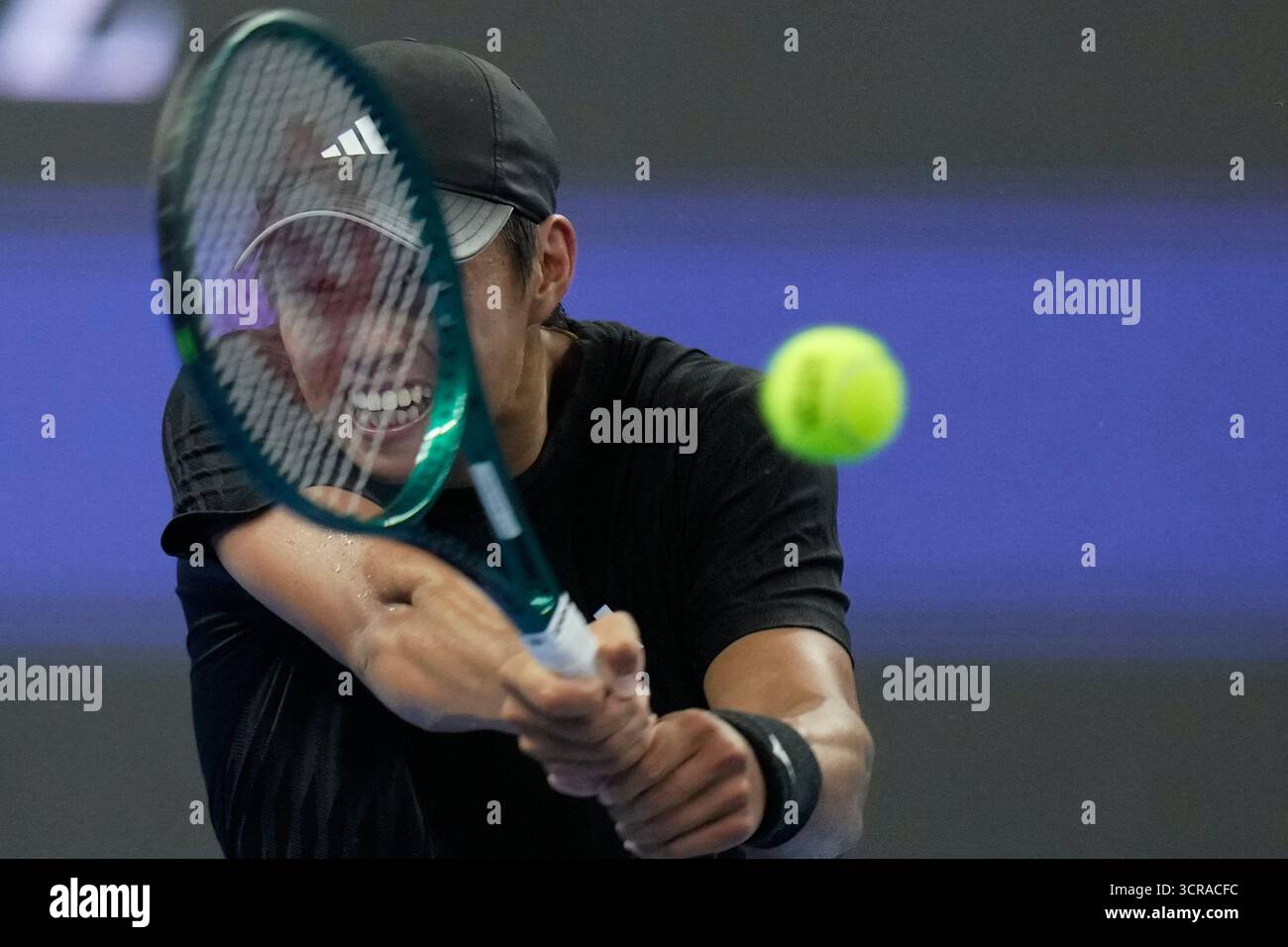 Learner Tien of the United States returns a backhand shot to Daniil ...