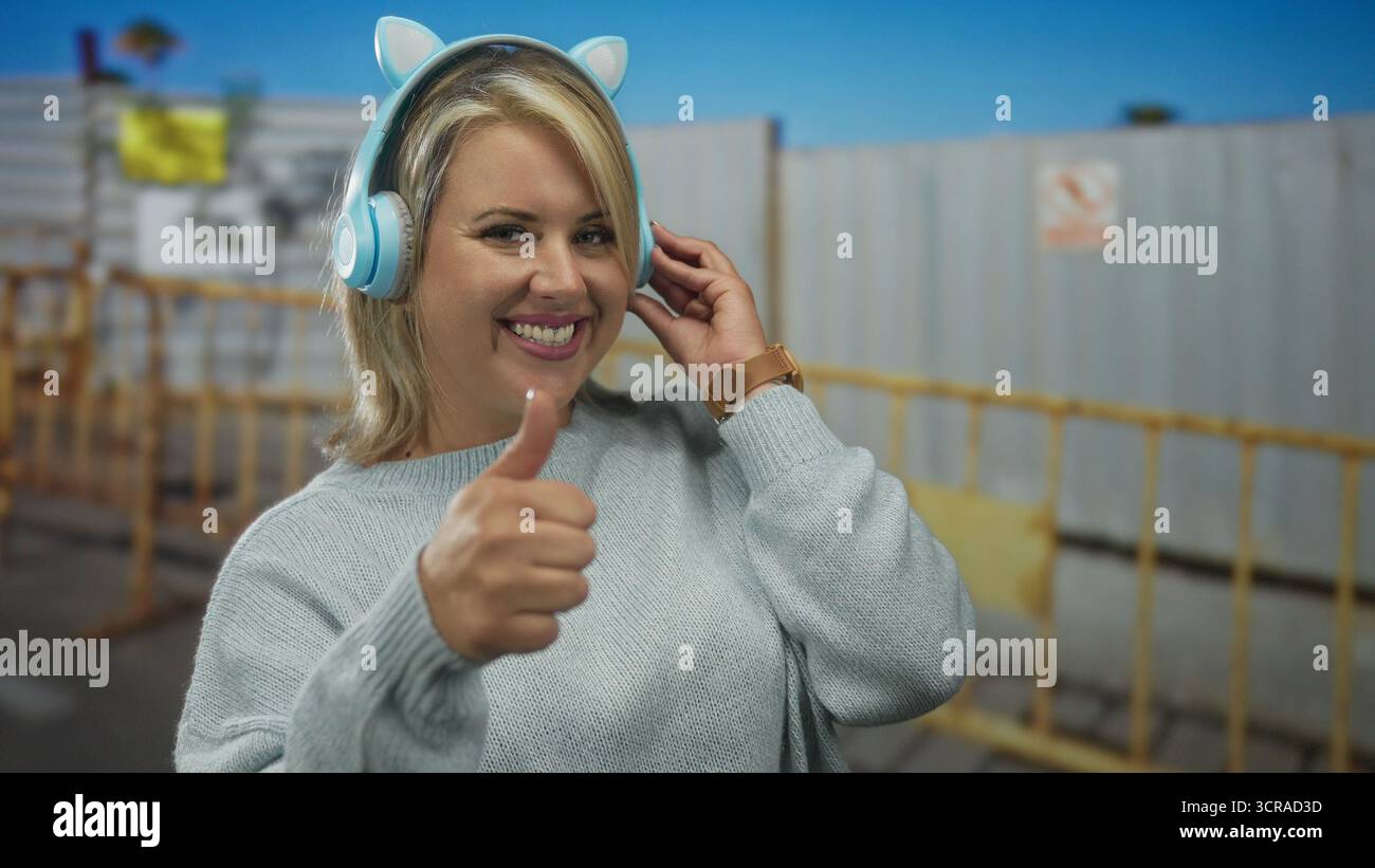 Woman building adjusts headphones hi-res stock photography and images ...