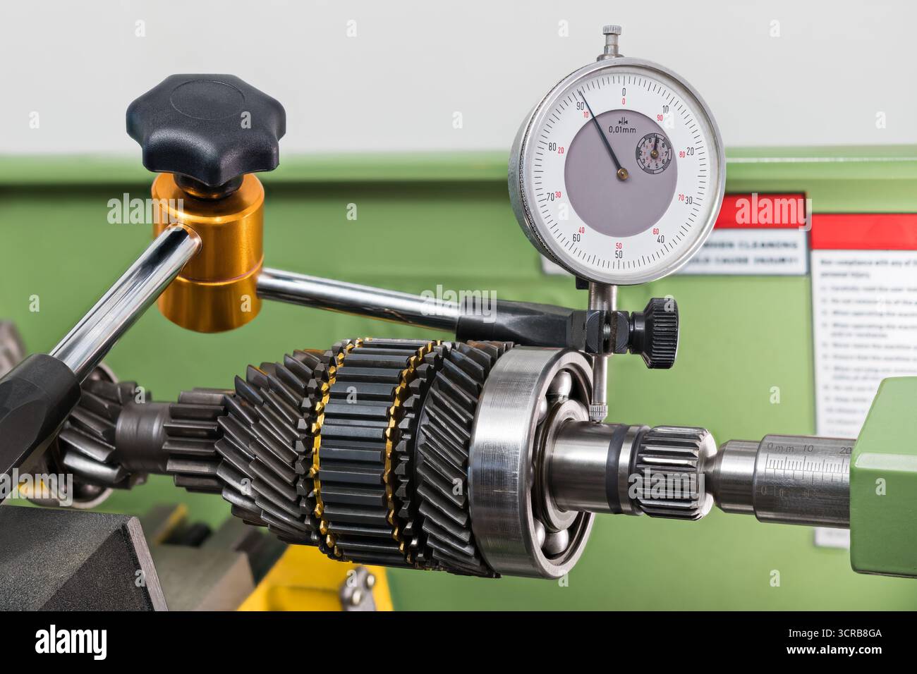 Closeup of dial indicator at measuring gearbox shaft runout in lathe ...