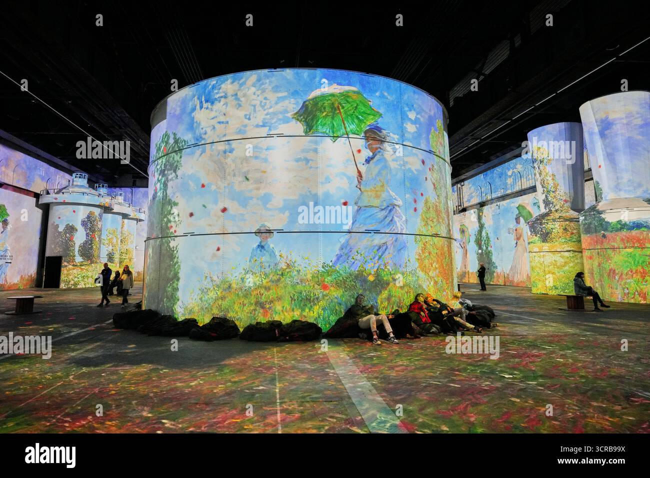 Visitors watch a digital immersive art exhibition, with 360-degree ...