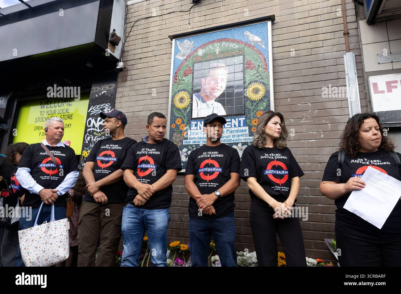 Relatives of Jean Charles de Menezes stand at his memorial outside ...