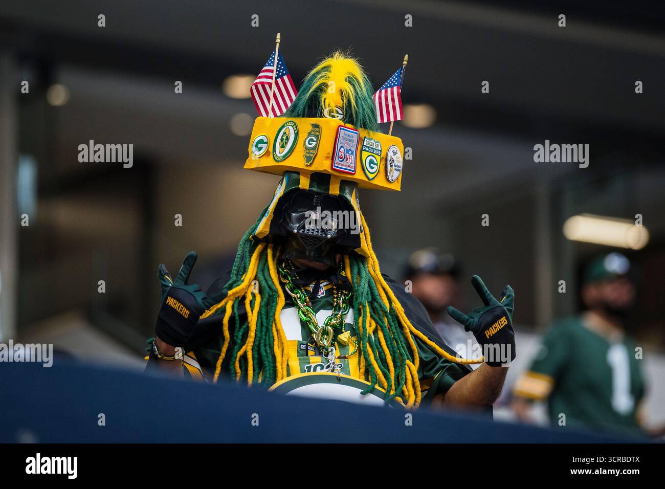 A Green Bay Packers fan cheers before an NFL football game against the ...