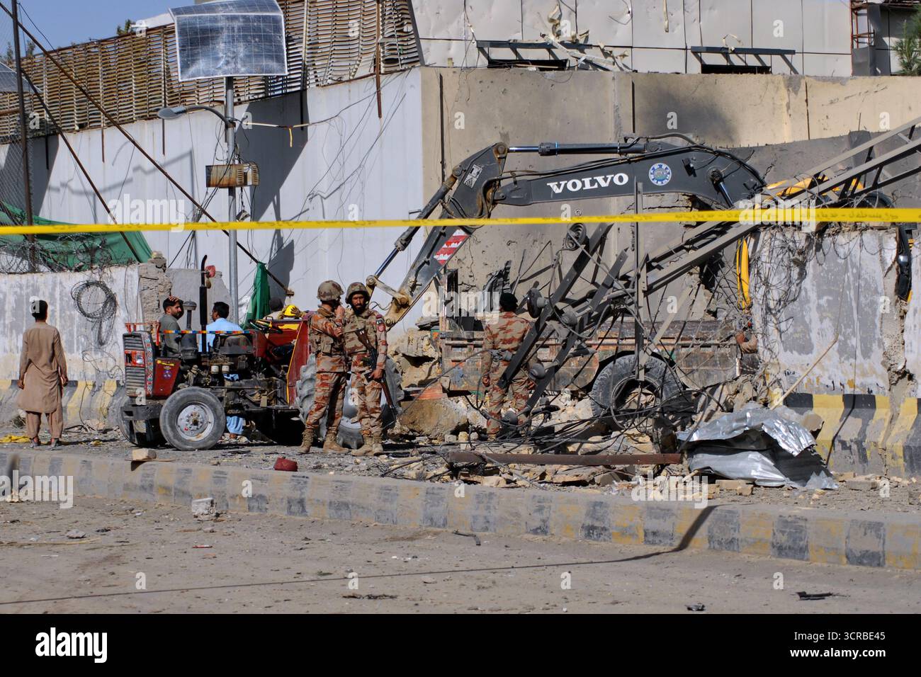 Security officers examine the damages at the site of a powerful car ...