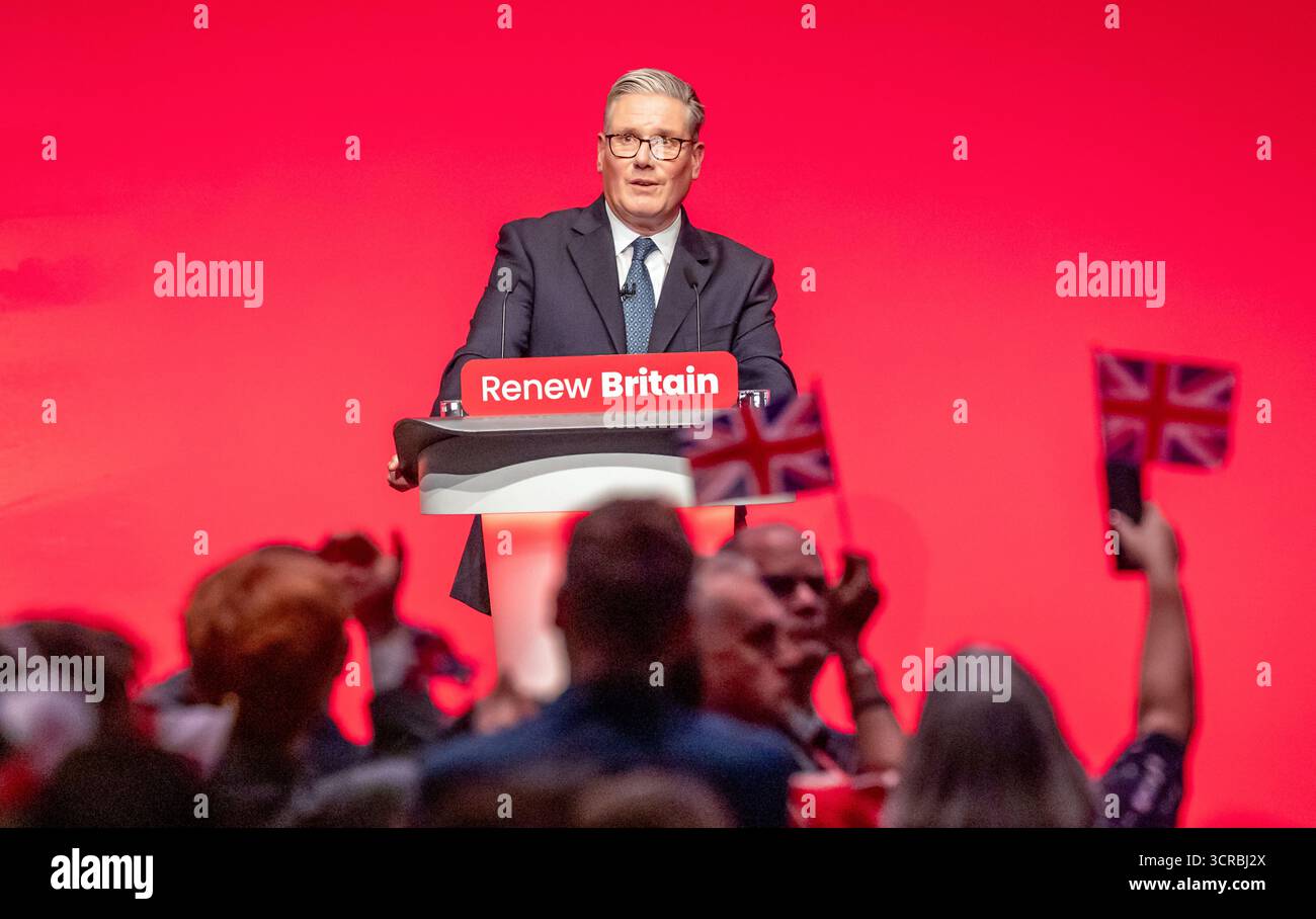 People wave flags as Prime Minister Sir Keir Starmer delivers his ...
