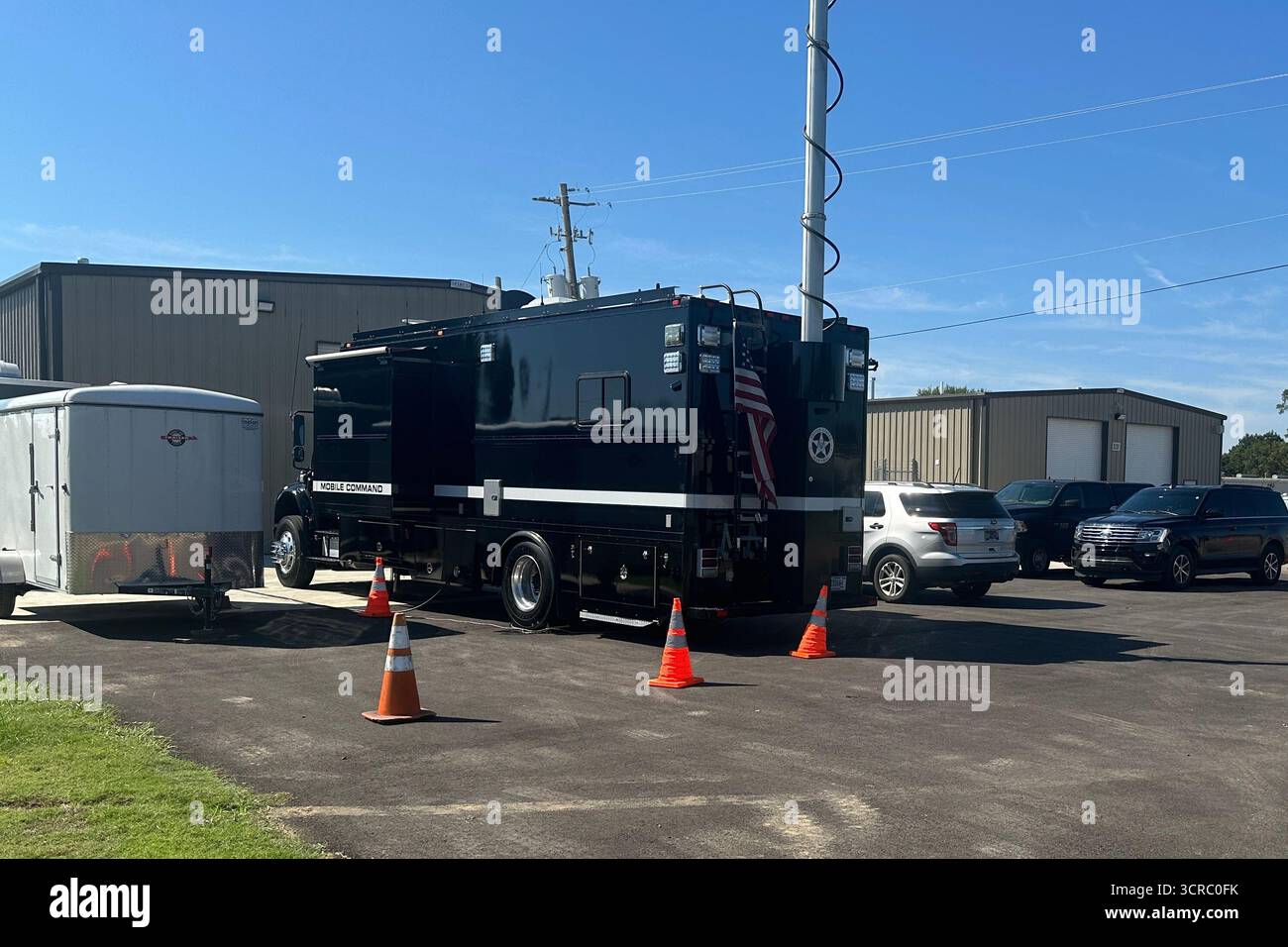 A U.S. Marshals Service mobile command center sits at a staging area on ...