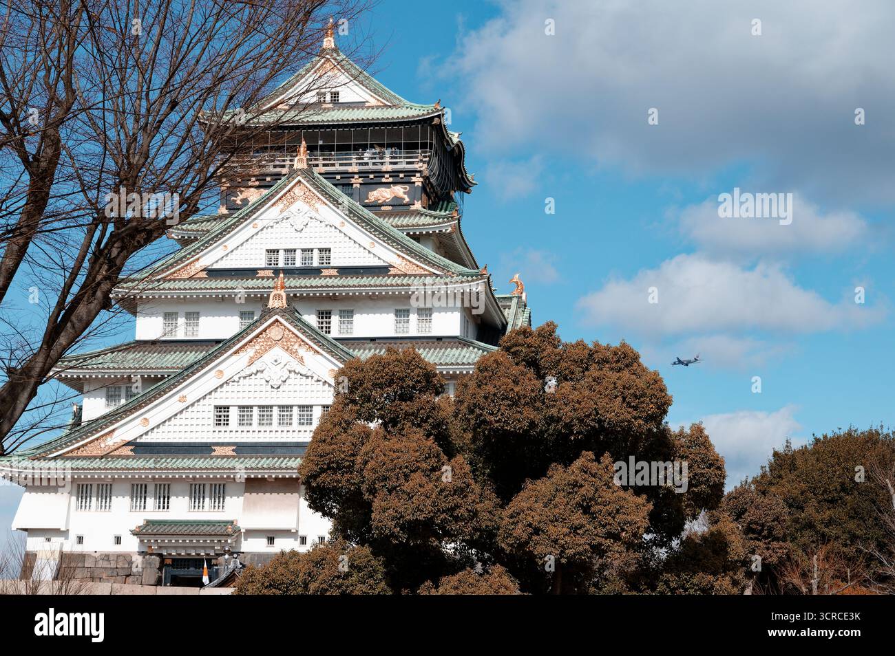 Osaka Castle in winter with an airplane passing in the distance Stock ...