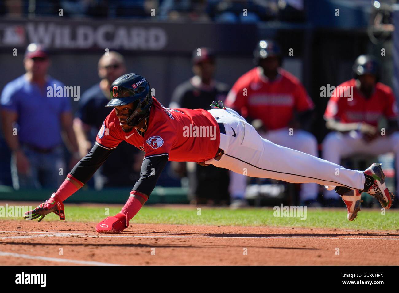 Cleveland Guardians' Angel Martínez dives into home plate to score on a ...