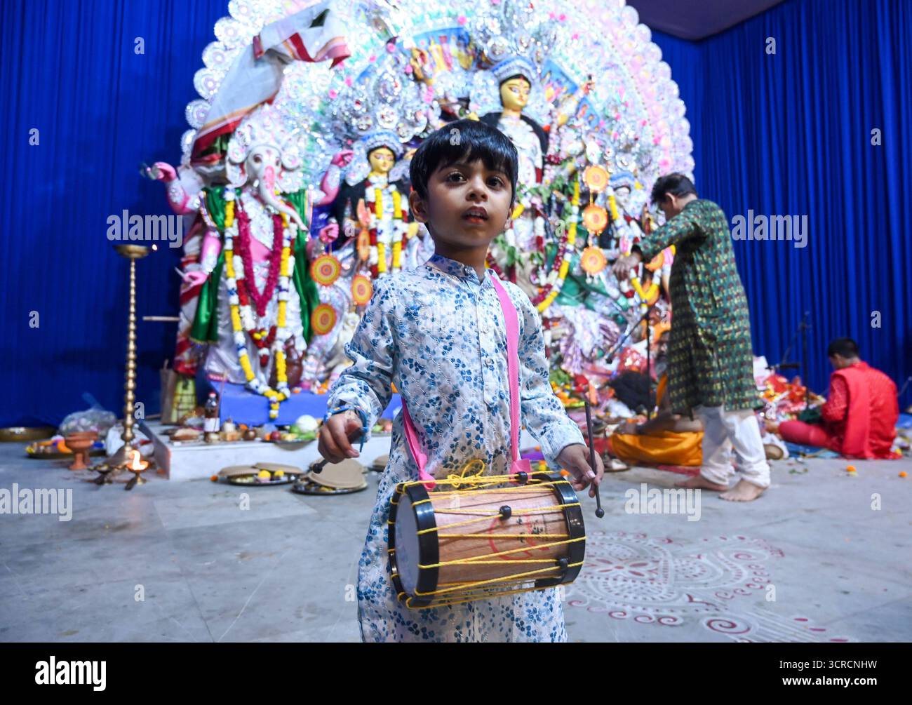 NOIDA, INDIA - SEPTEMBER 30: Devotees light earthen lamps Diyas while ...
