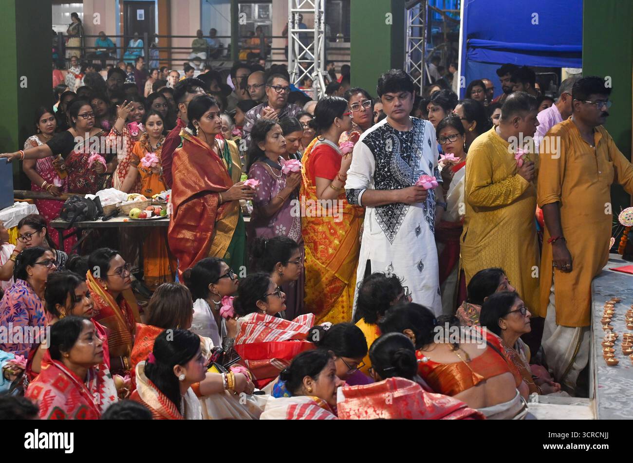 NOIDA, INDIA - SEPTEMBER 30: Devotees light earthen lamps Diyas while ...