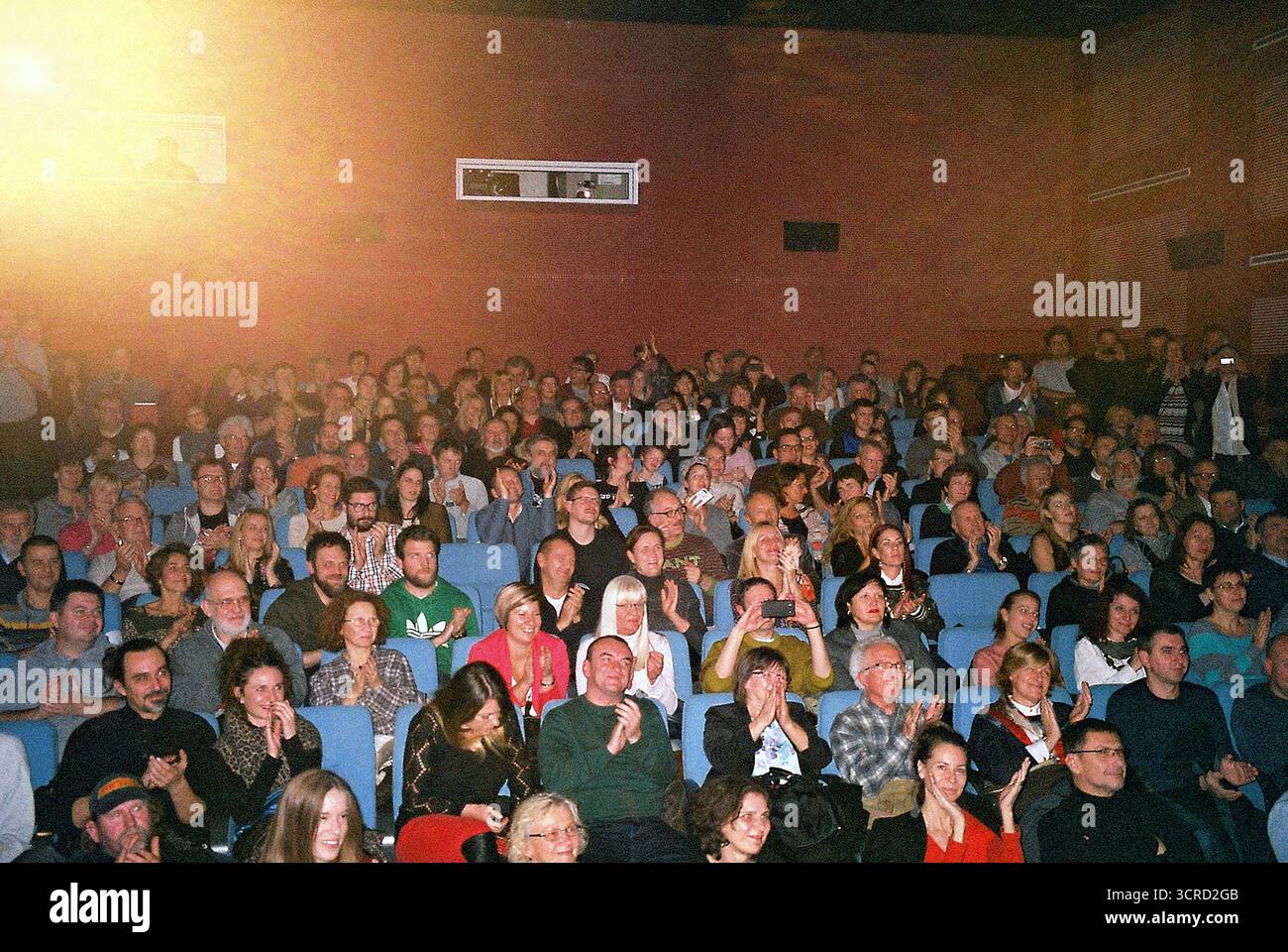 Analog photo from stage: audience at KC Novi Sad stands and applauds ...