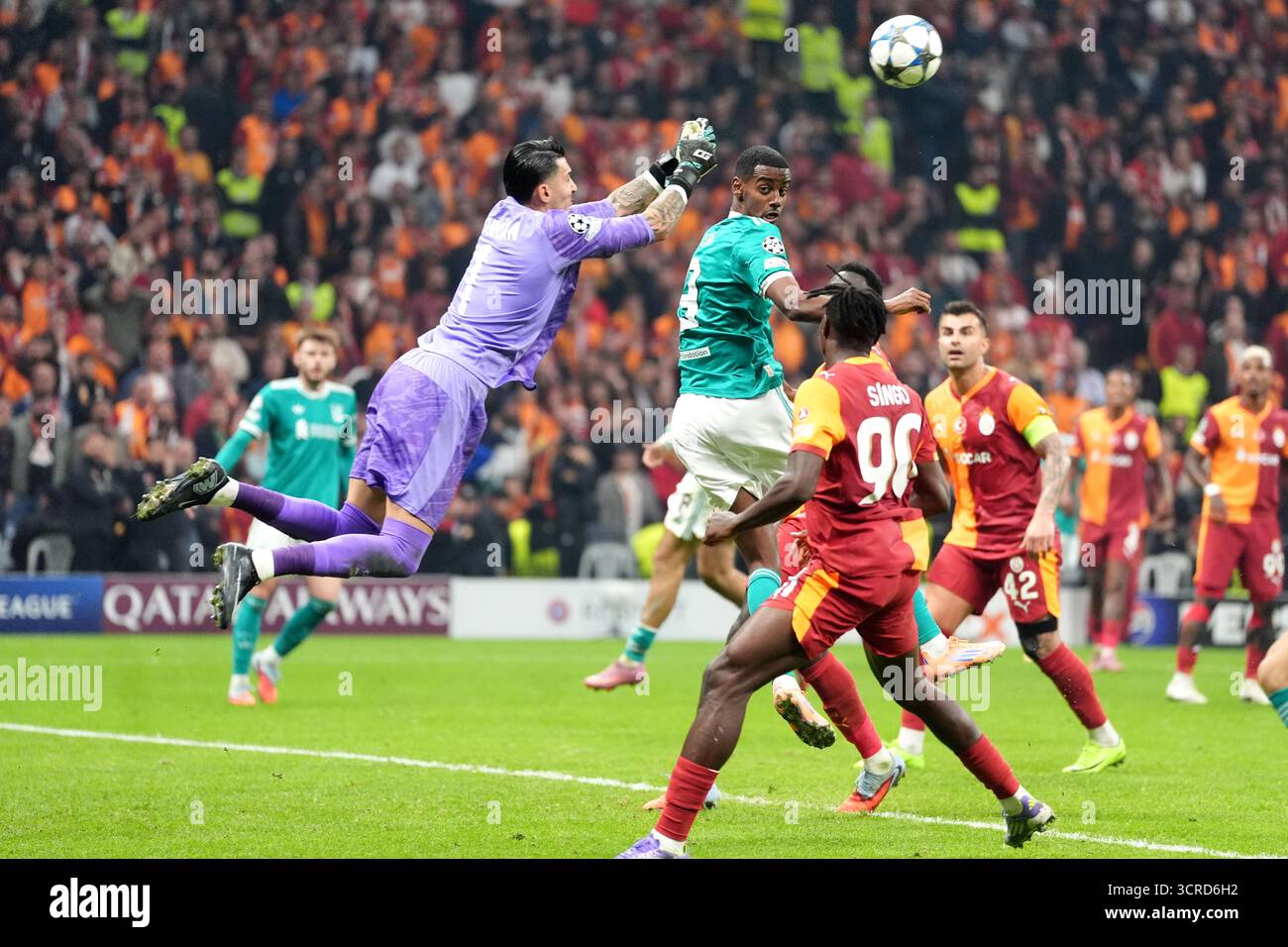 Galatasaray goalkeeper Ugurcan Cakir (left) punches the ball clear from Liverpool's Alexander ...