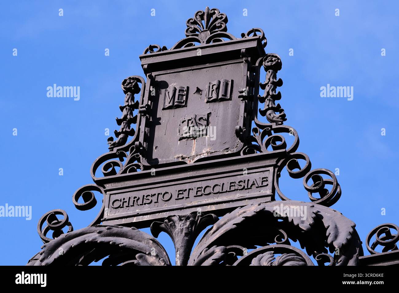 The Harvard University logo is displayed on a metal gate leading to ...