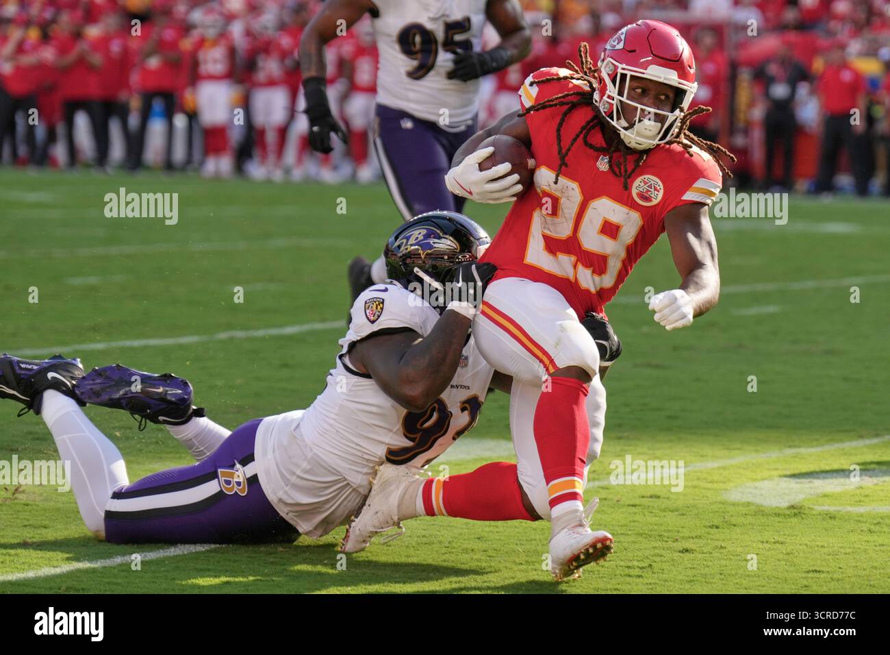 Kansas City Chiefs running back Kareem Hunt (29) gets past Baltimore Ravens defensive tackle ...
