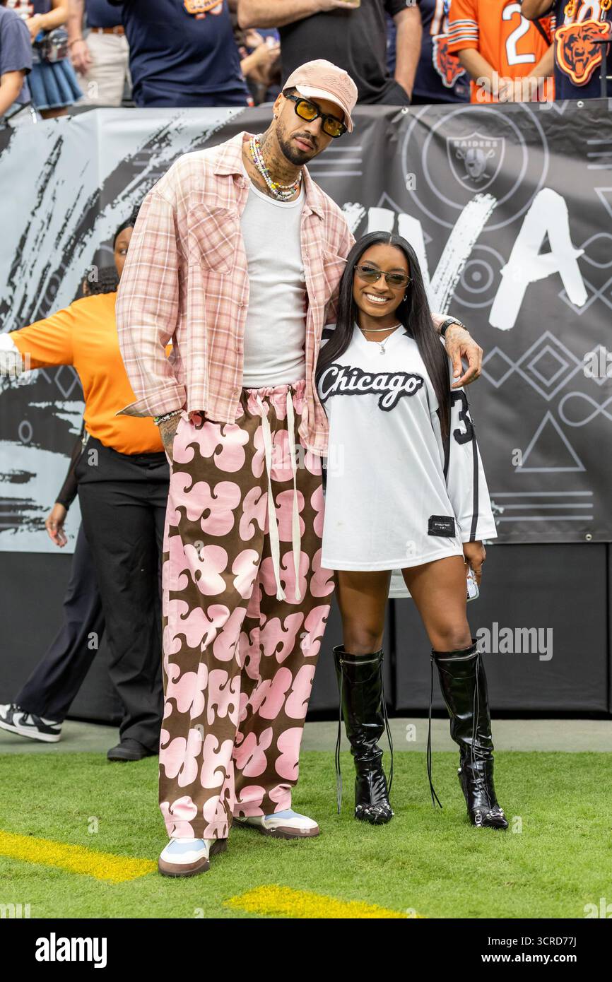 Gymnast Simone Biles, right, poses with fencer Miles Chamley-Watson ...