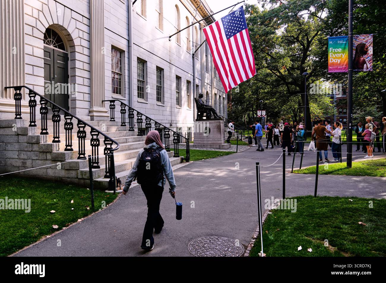 A woman walks through Harvard Yard at Harvard University, Tuesday, Sept ...