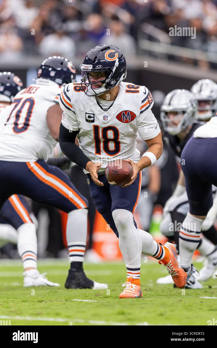 Chicago Bears quarterback Caleb Williams (18) turns to hand off against the Las Vegas Raiders in ...