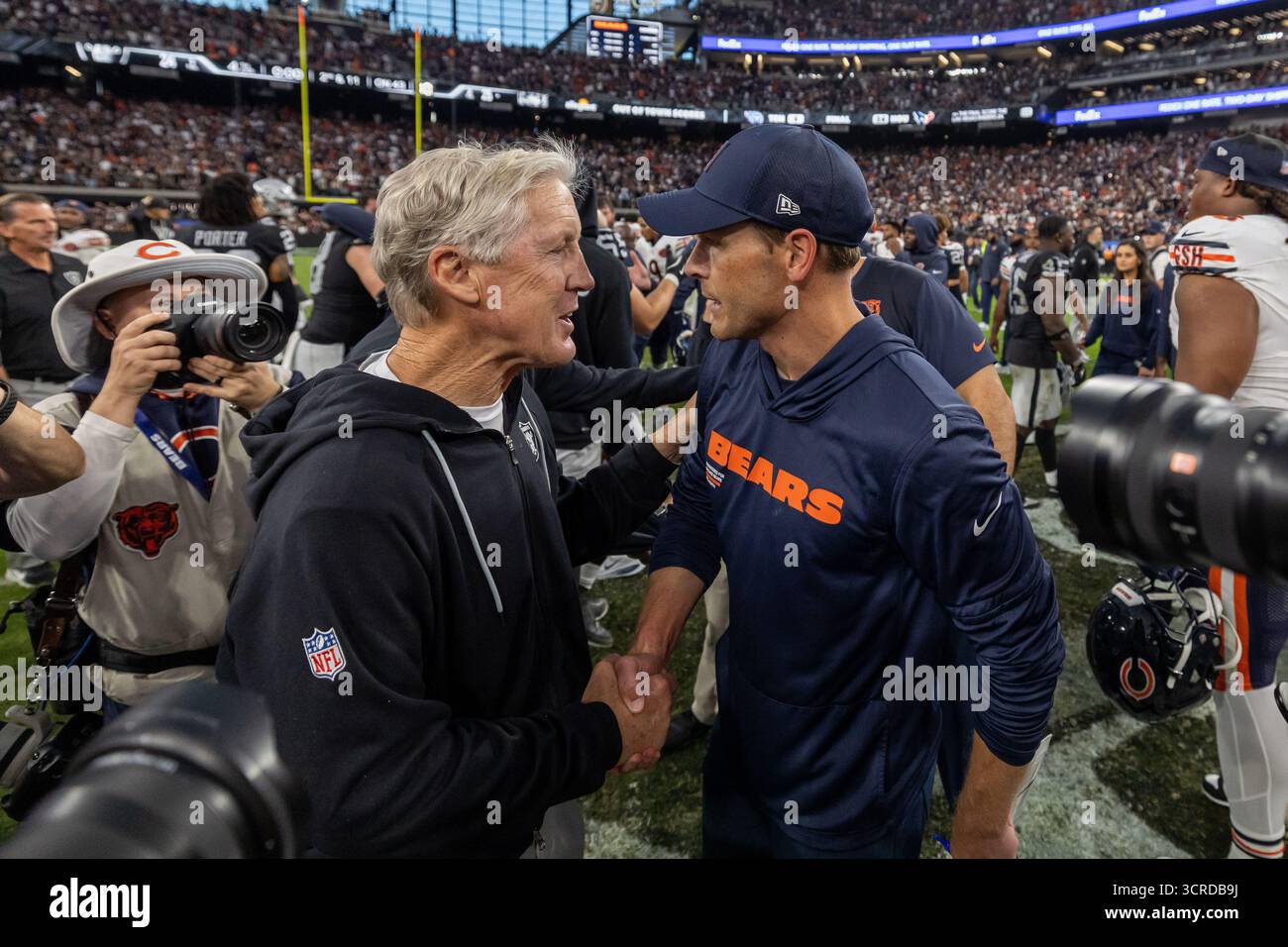 Chicago Bears head arch Ben Johnson, r, shakes hands with Las Vegas ...