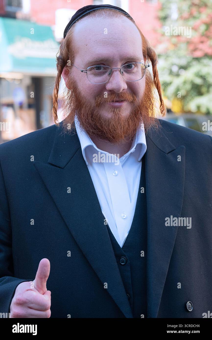 A head & shoulders photo of a cheerful hasidic Jew with red hair ...