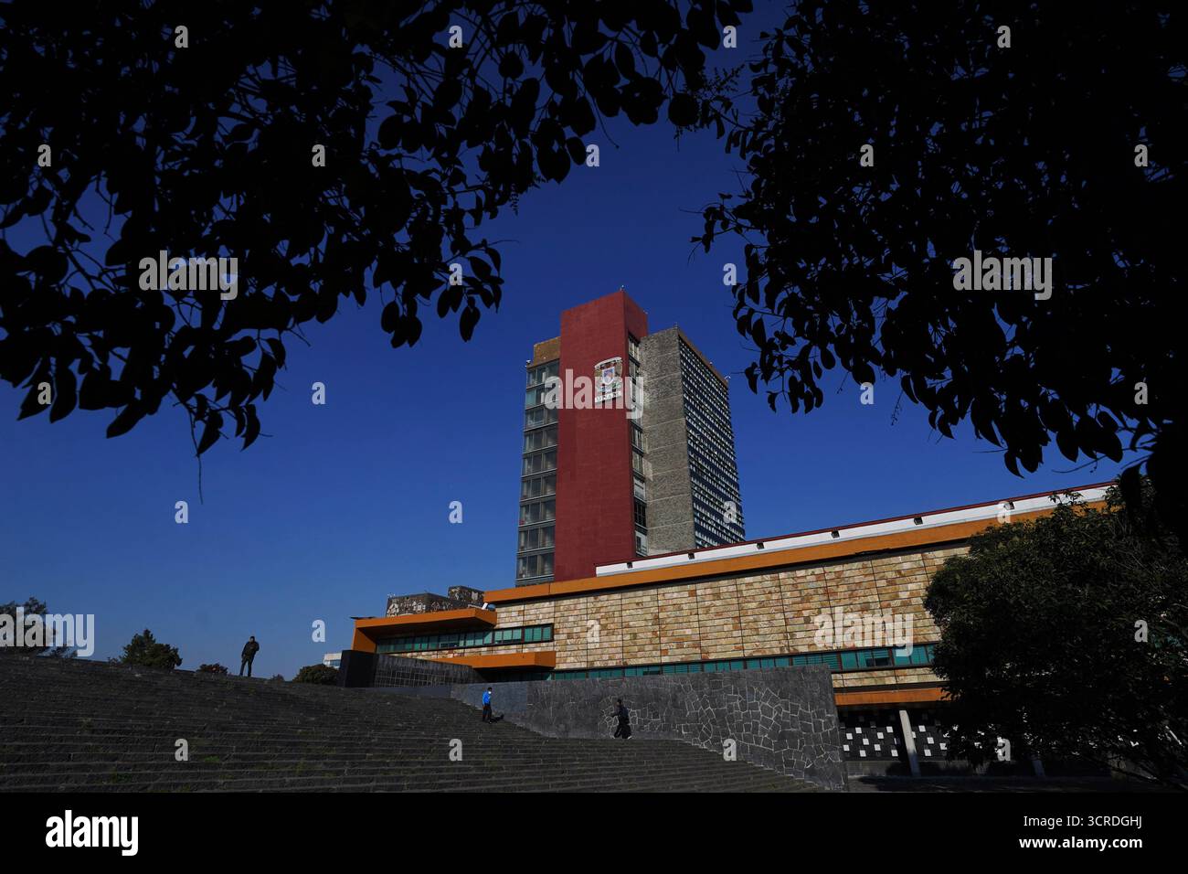 FILE - People walk by the Dean's Office Building of the National ...