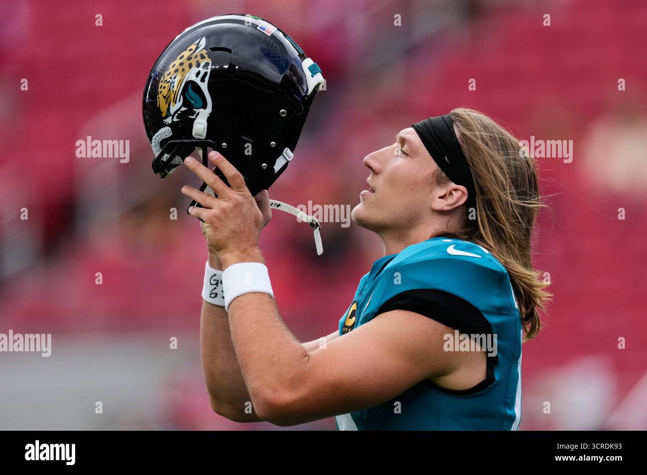 Jacksonville Jaguars quarterback Trevor Lawrence puts on his helmet ...