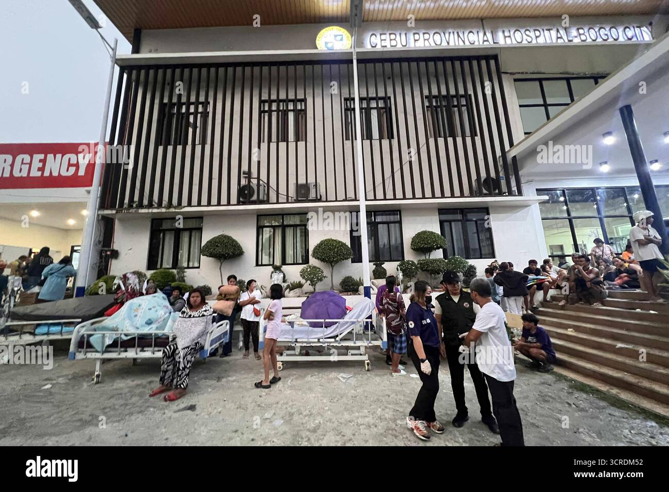 Patients wait outside the Cebu Provincial Hospital Bogo City after a ...