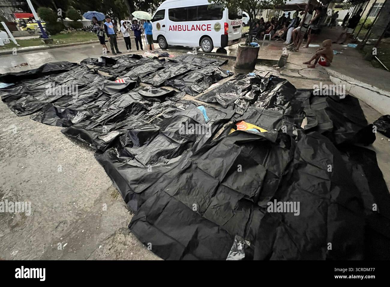 Bodies of victims lie covered outside the Cebu Provincial Hospital Bogo ...