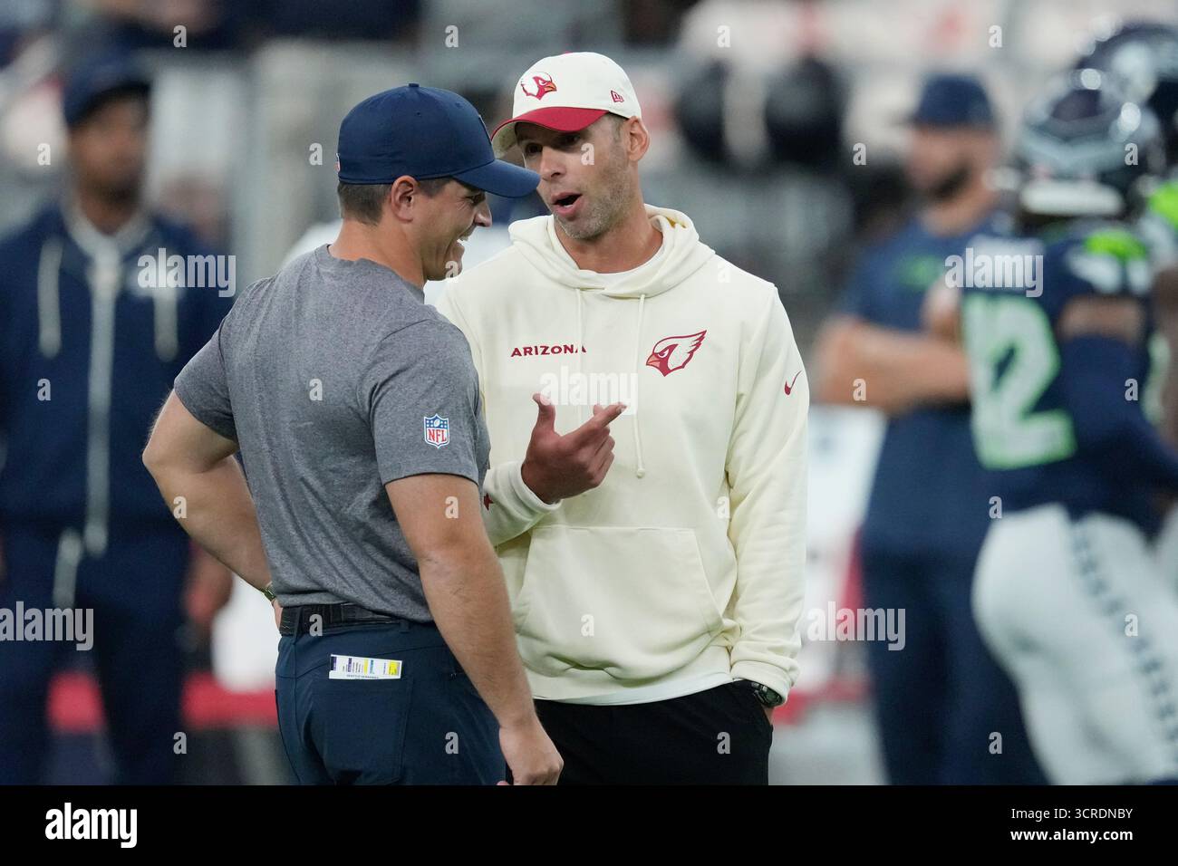 Arizona Cardinals head coach Jonathan Gannon, right, talks with Seattle ...