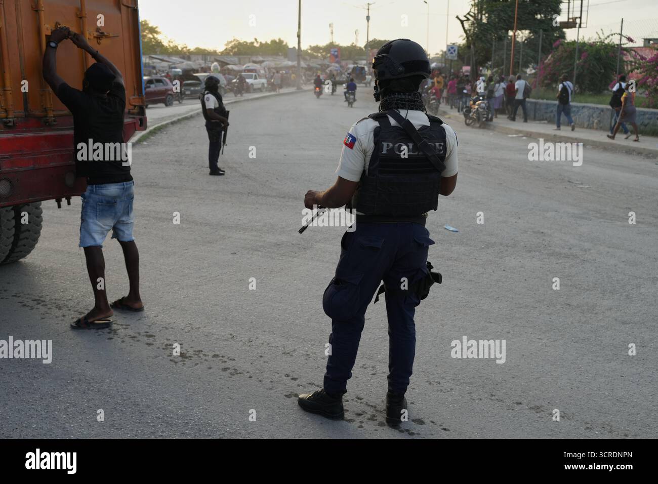 Police officers patrol an intersection in Port-au-Prince, Haiti ...