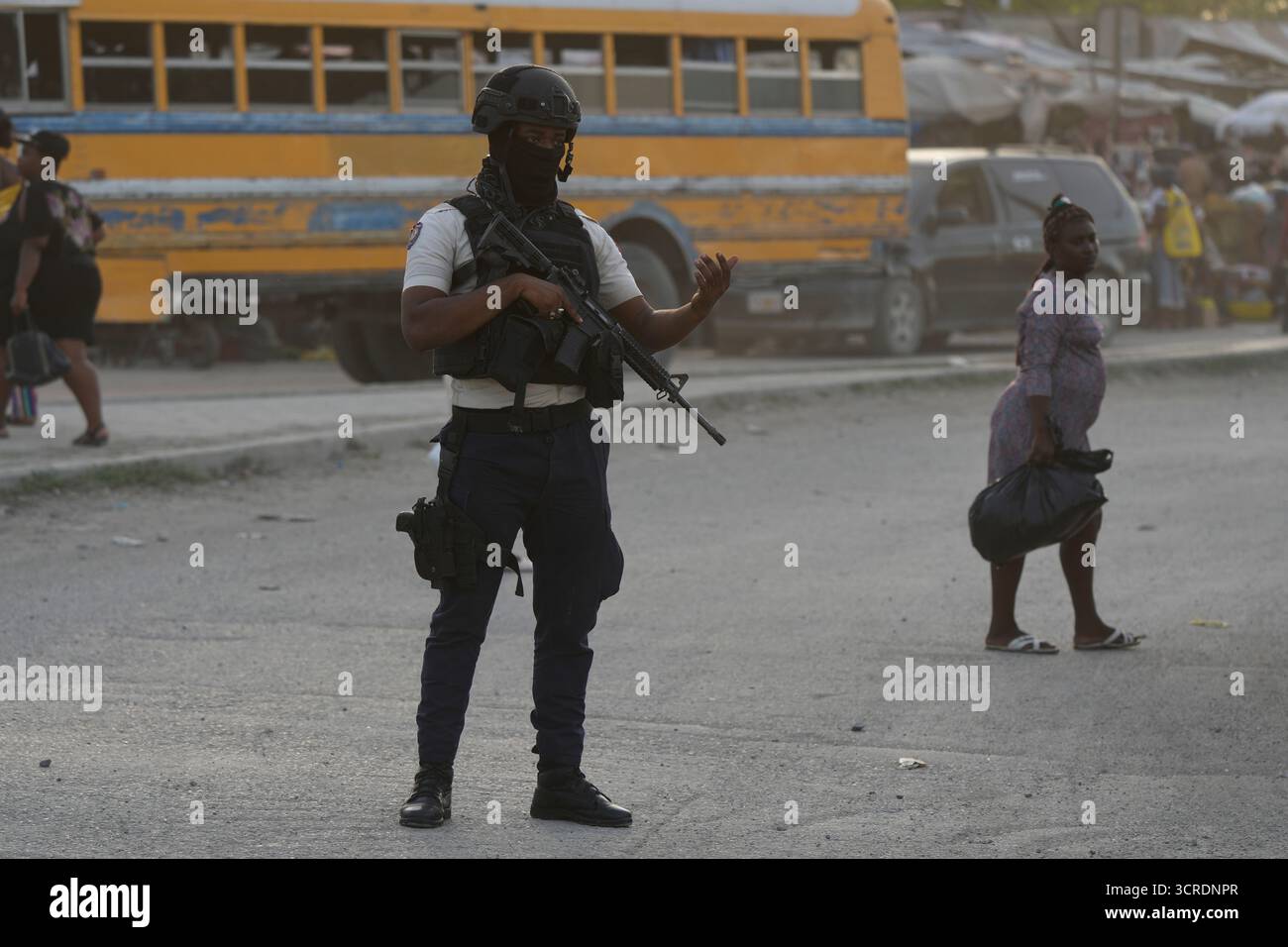Police officers patrol an intersection in Port-au-Prince, Haiti ...