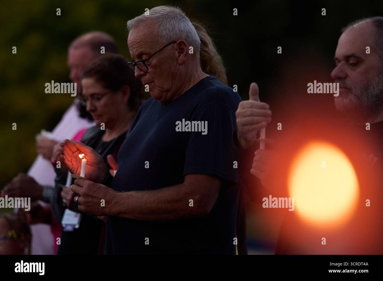 Mourners gather during a vigil held at the Henry Ford Genesys Regional ...