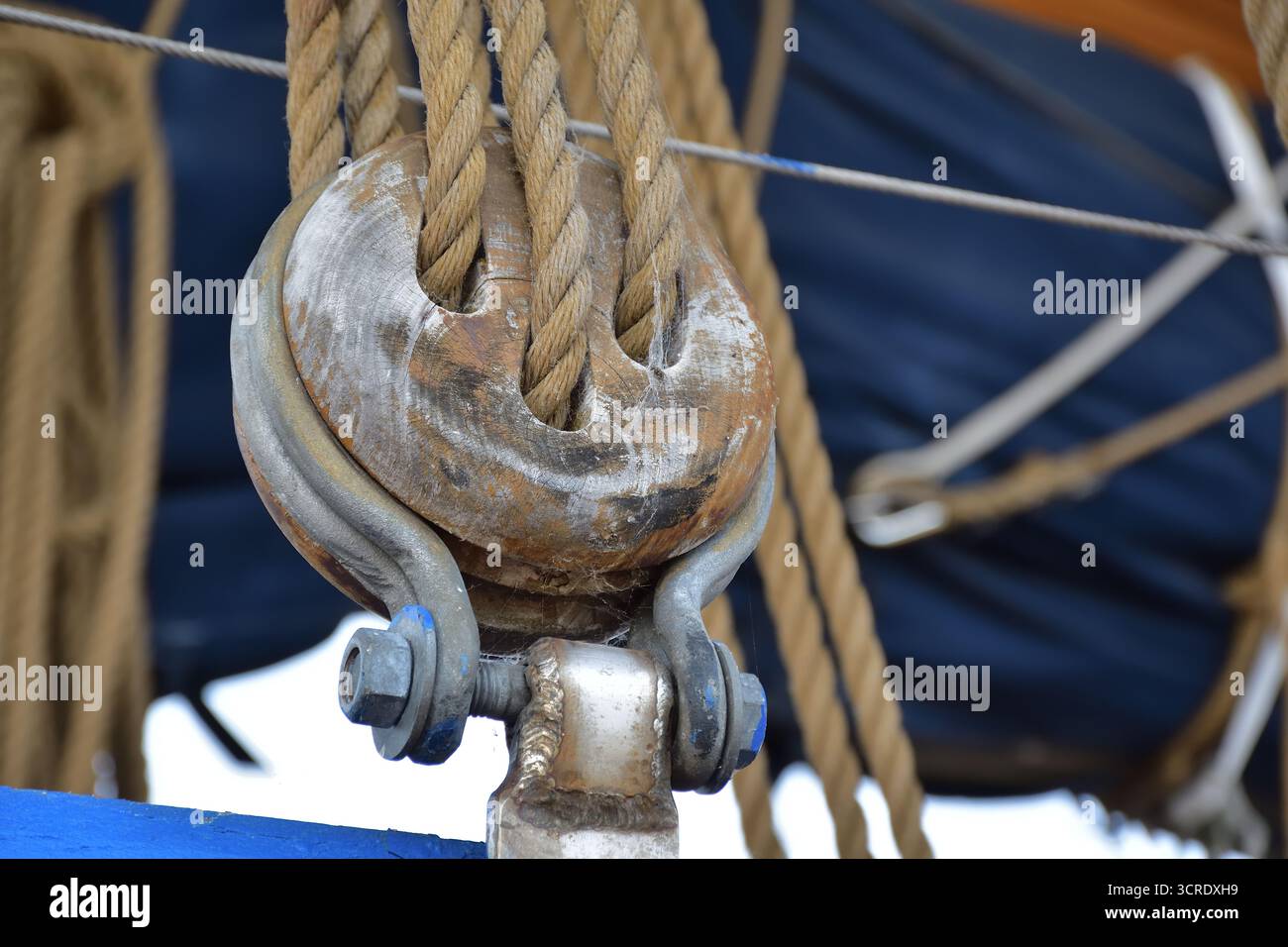 Wooden triple deadeye for sailing ship with lanyard Stock Photo - Alamy