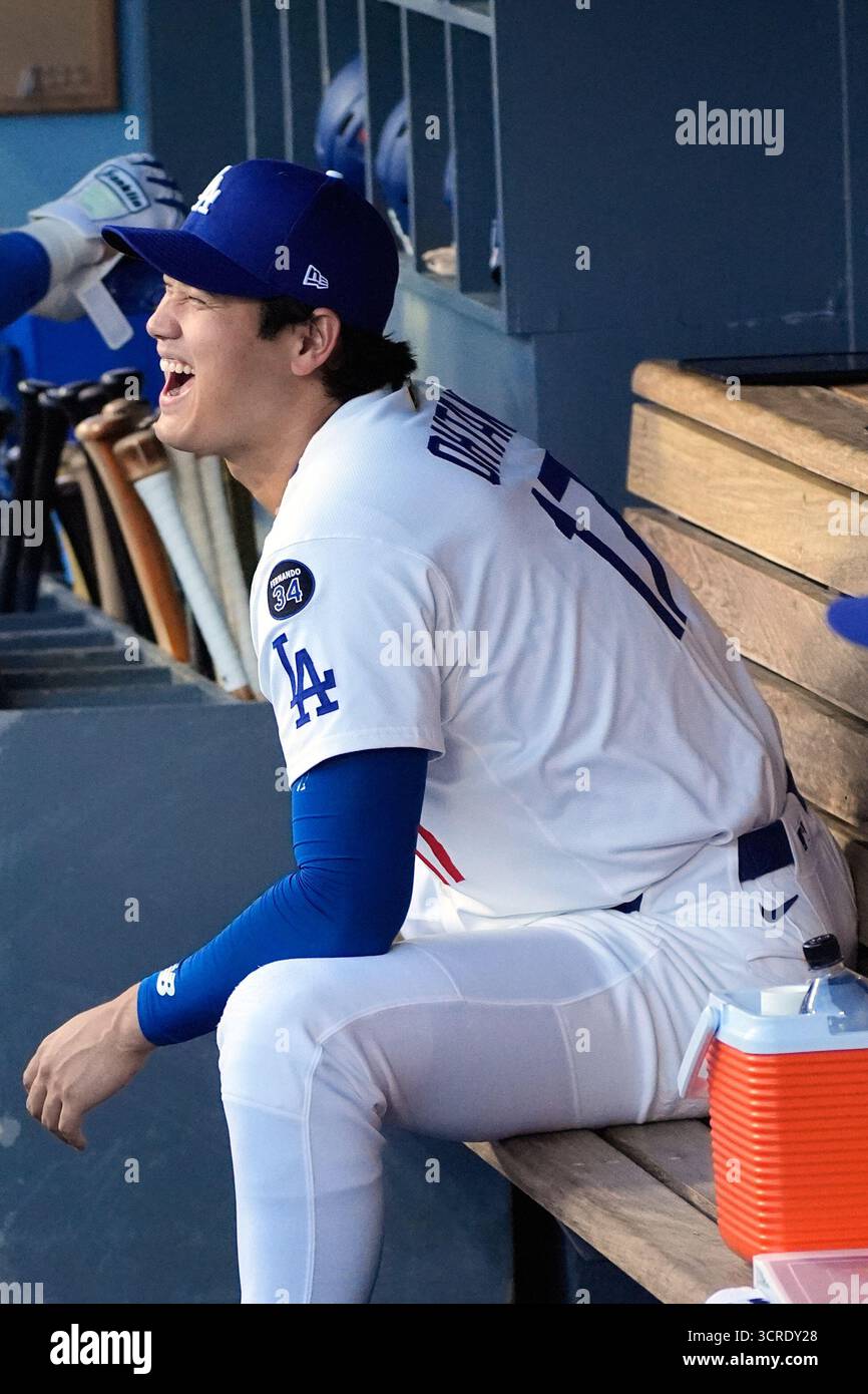 Los Angeles Dodgers' Shohei Ohtani smiles in the dugout before Game 1 ...