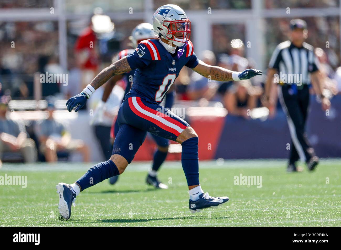 New England Patriots cornerback Christian Gonzalez (0) drops into ...
