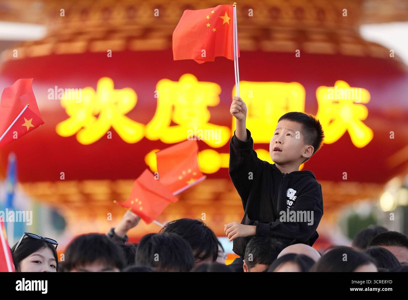 Beijing, China. 1st Oct, 2025. A boy is pictured at a flag-raising ...