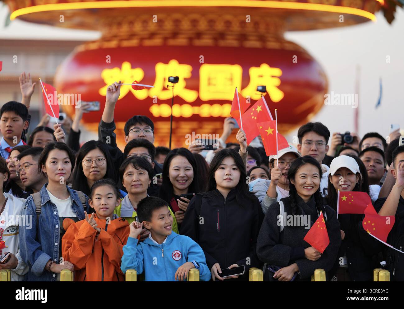Beijing, China. 1st Oct, 2025. People attend a flag-raising ceremony ...