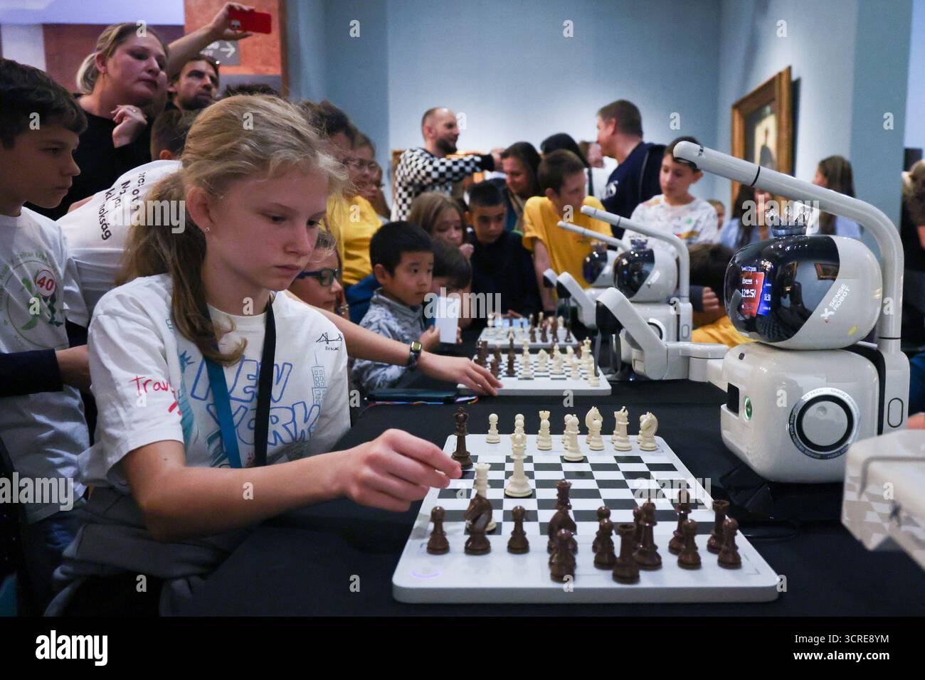 Budapest, Hungary. 30th Sep, 2025. Children play with a chess robot at ...