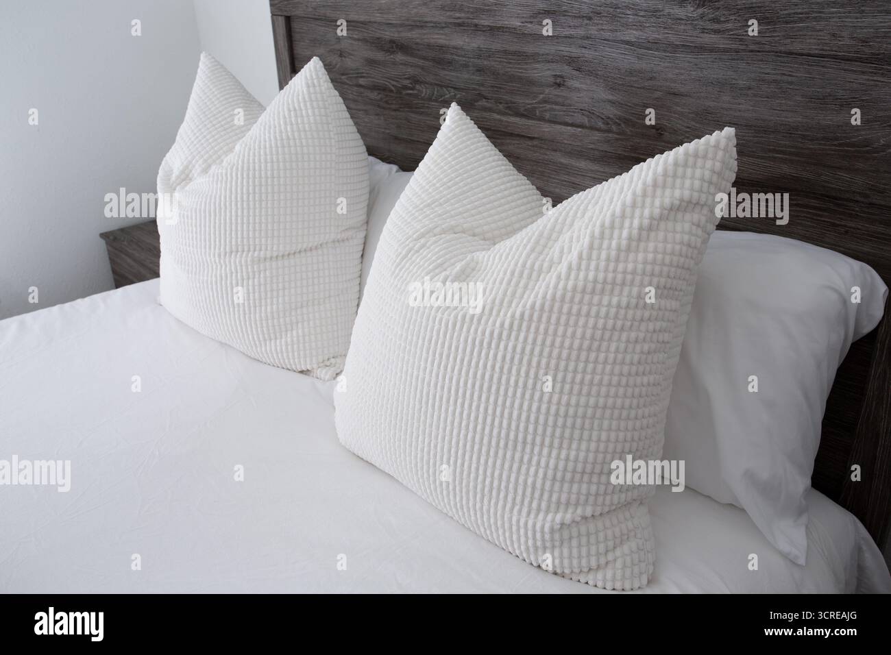A view of a white bed arrangement design, featuring pillows and a bed ...