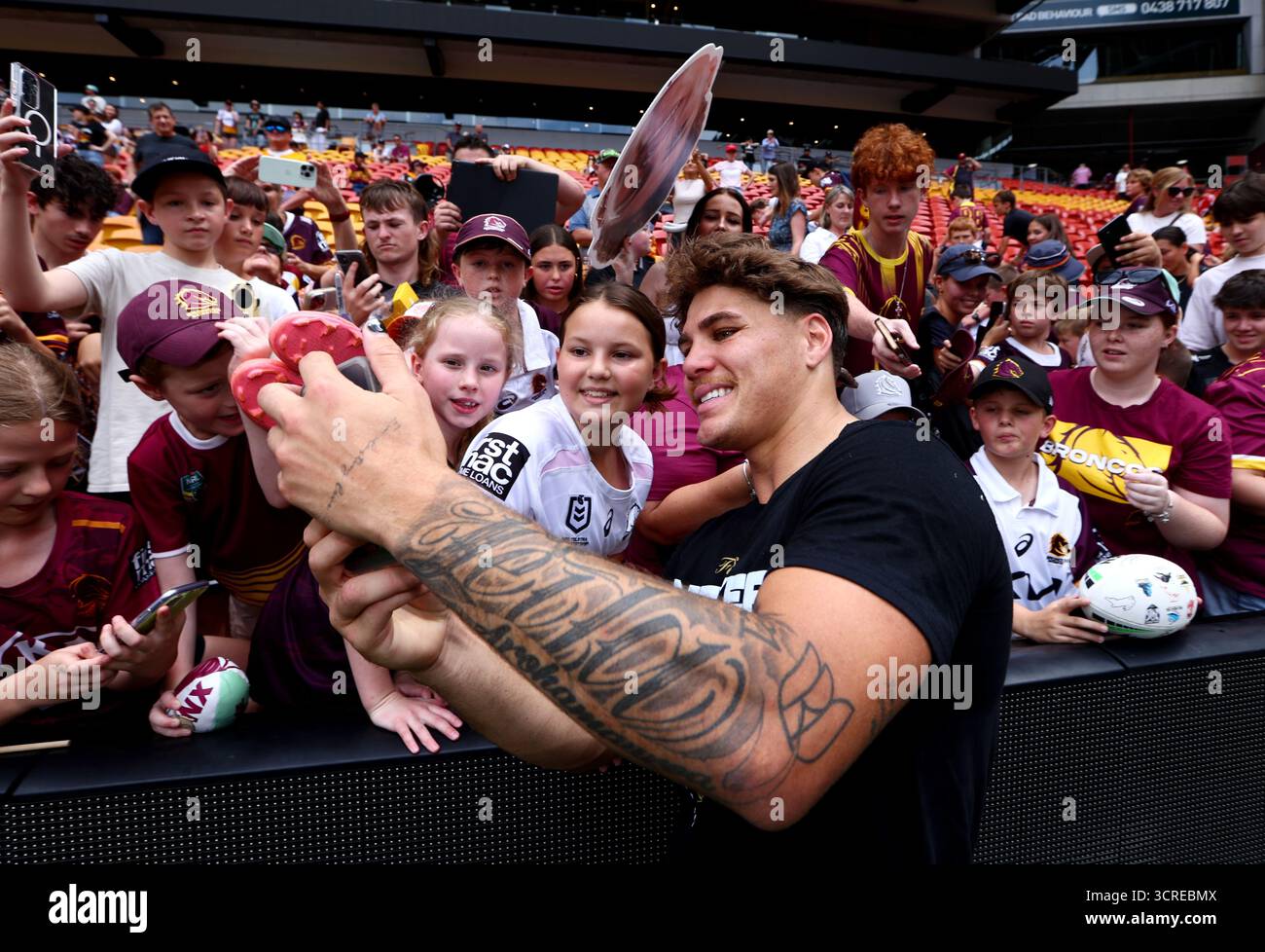 Reece Walsh of the Broncos interacts with fans during an open training ...