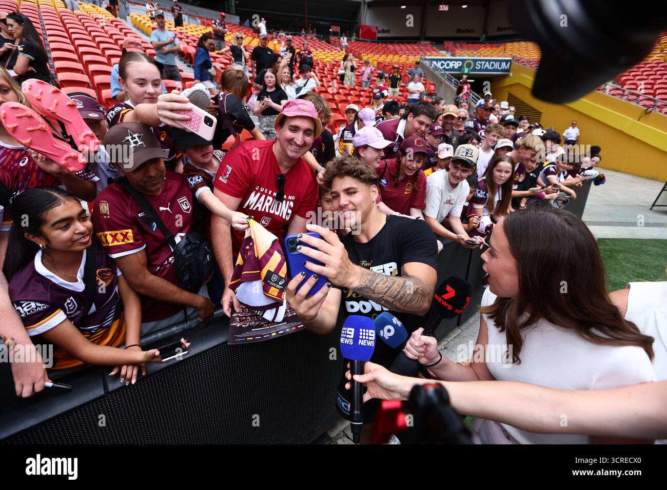 Reece Walsh interacts with Broncos fans during an open training session ...