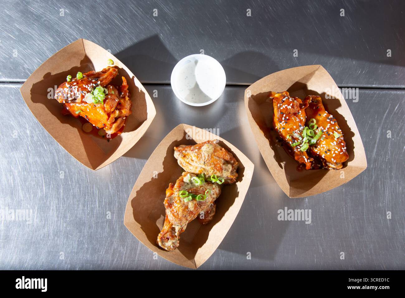 A top down view of several orders of chicken wing flavors Stock Photo ...