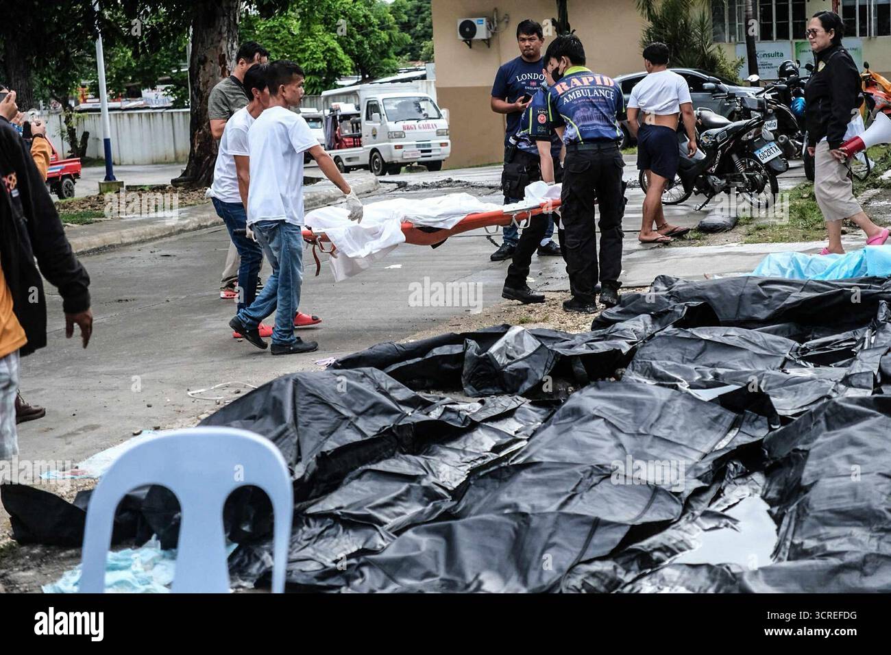 A body on stretcher is carried in Bogo City, Cebu province, Philippines ...