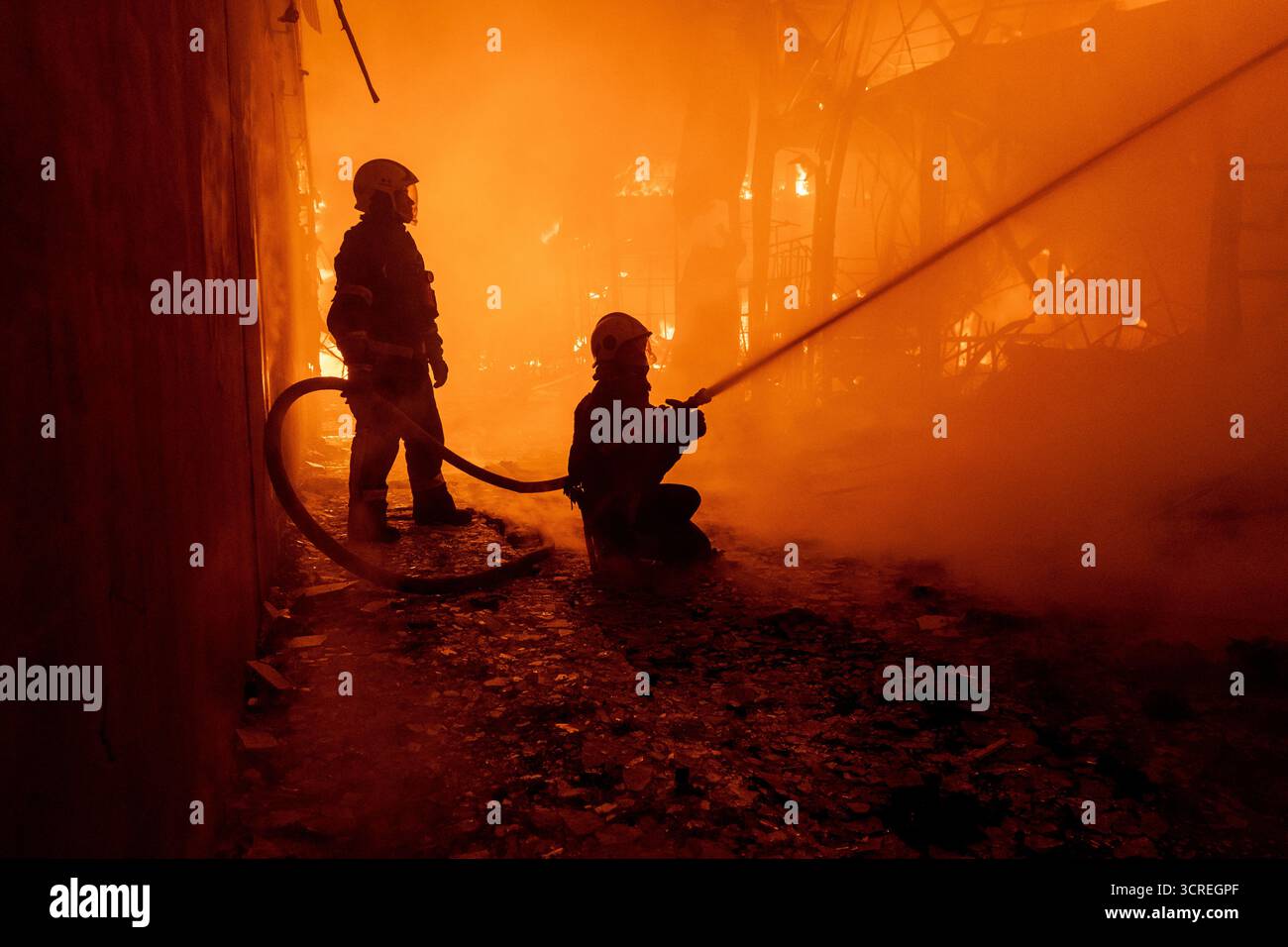 Firefighters tackle the blaze after a Russian air attack that hit at ...