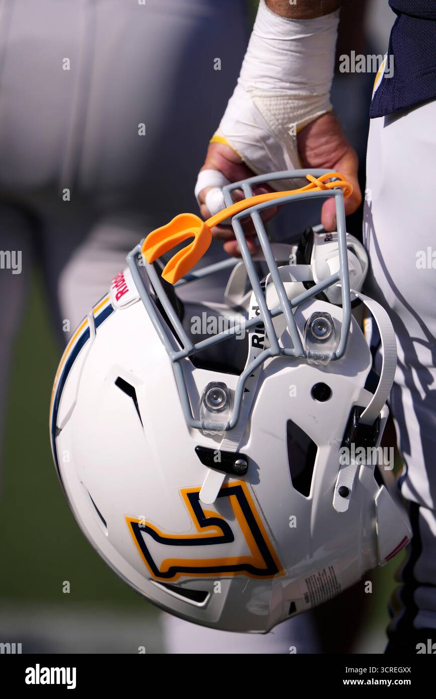 Lycoming College nose tackle Tom Cillo holds his helmet on the ...