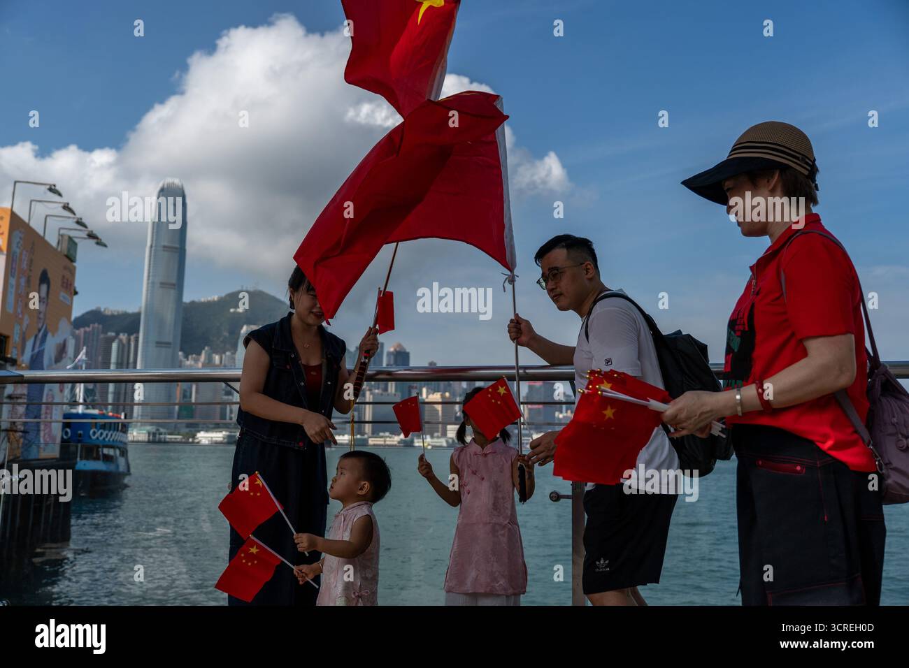 Pro-Beijing supporters waving the national flag of china in Tsim Sha ...