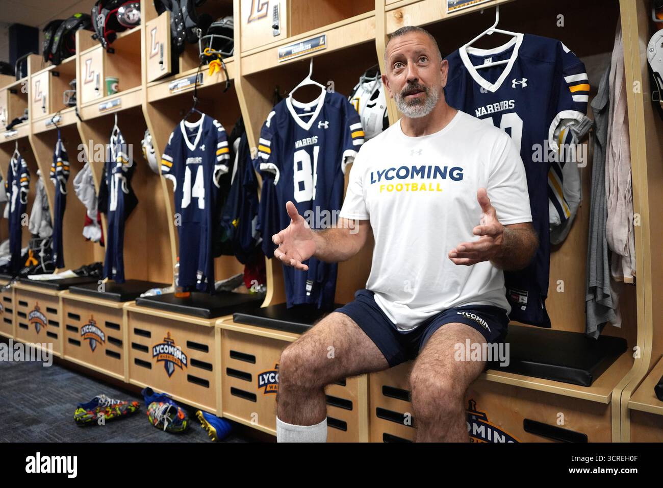 Lycoming College nose tackle Tom Cillo sits in his locker in the team's ...