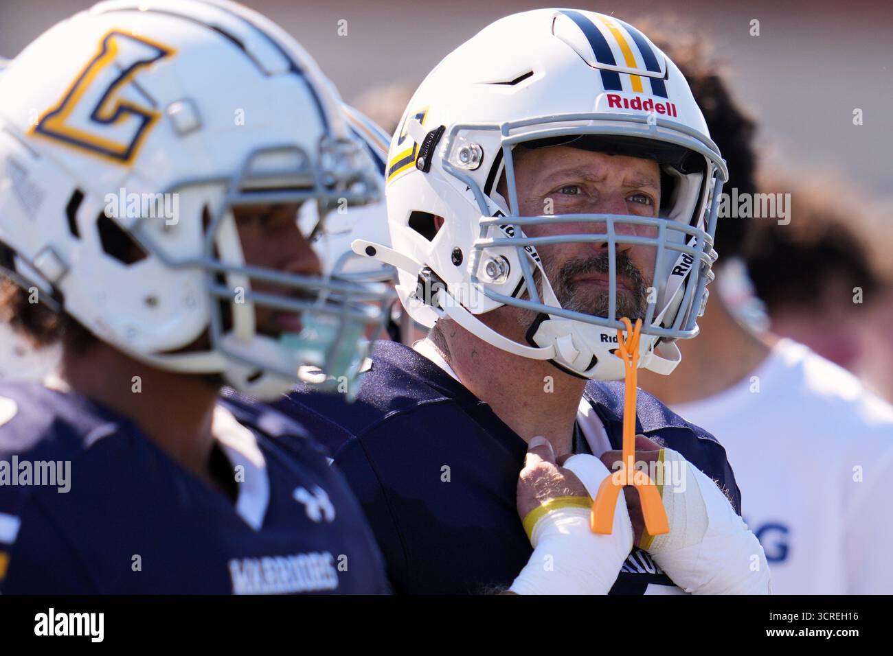 Lycoming College nose tackle Tom Cillo, right, stands on the sidelines ...