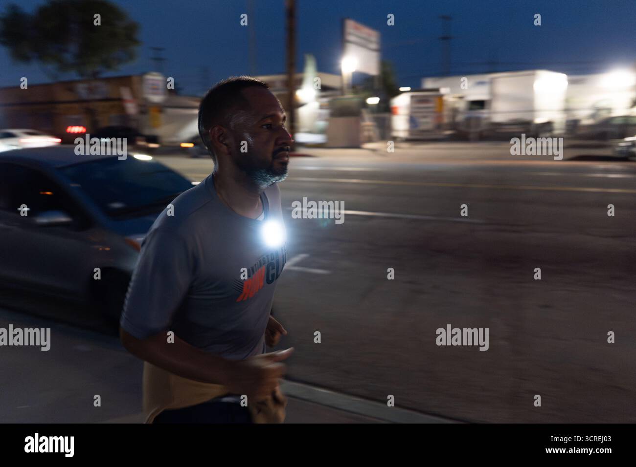 Raul Escobar, a member of the Huntington Park Run Club, runs with a ...