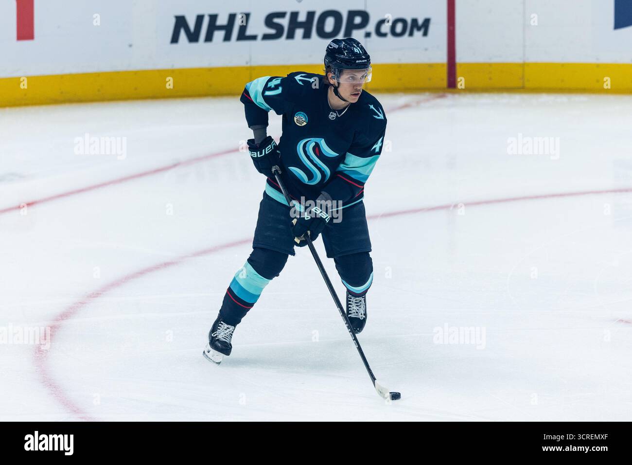 Seattle Kraken defenseman Ryker Evans skates with the puck during a pre ...